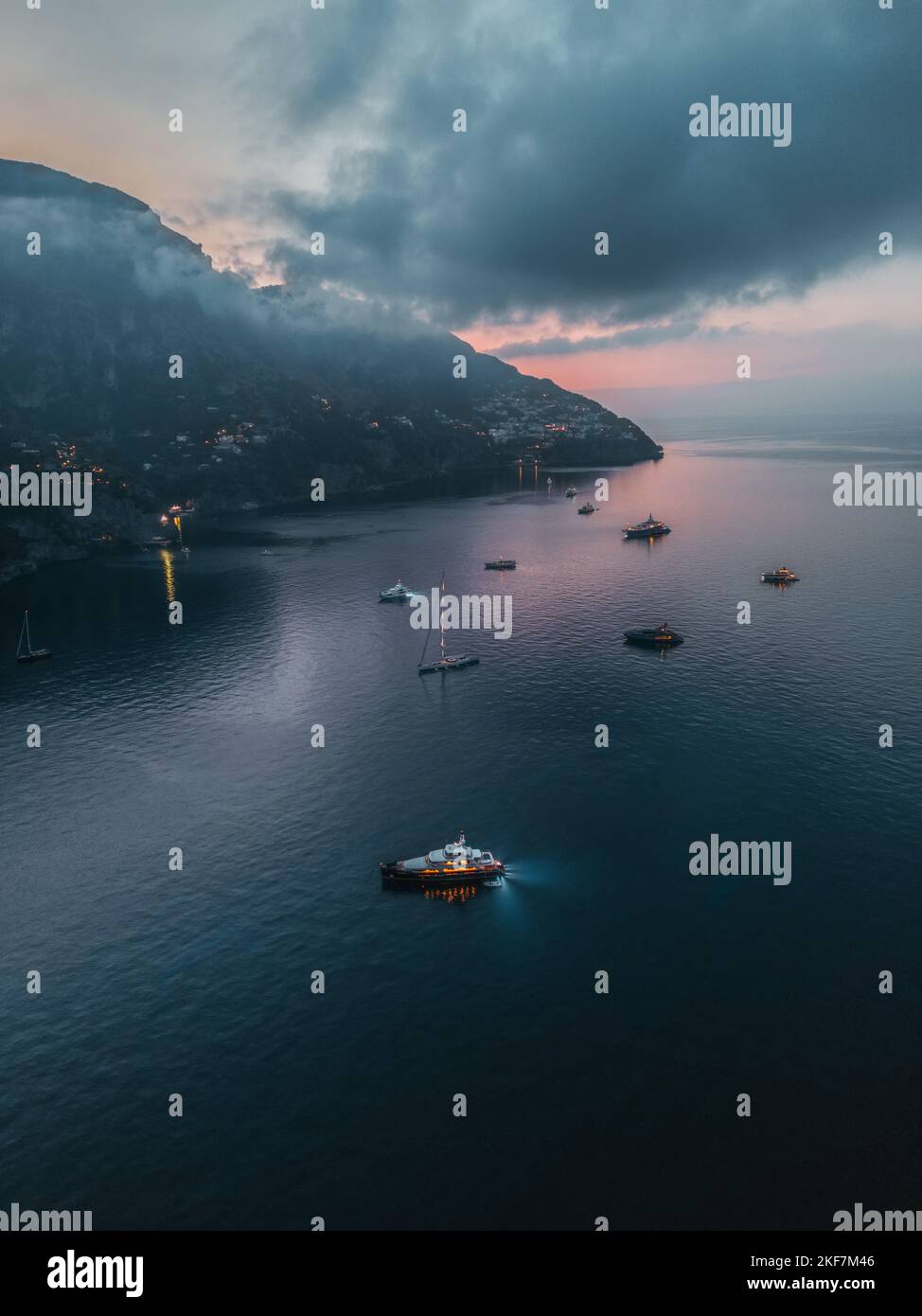 A vertical drone shot of boats and ships floating on water by the ...