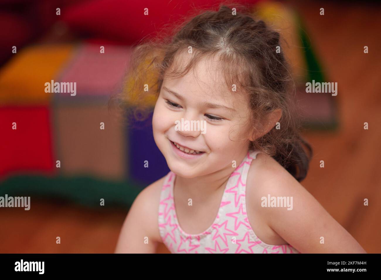 portrait of a young girl in the livingroom at home making faces and ...