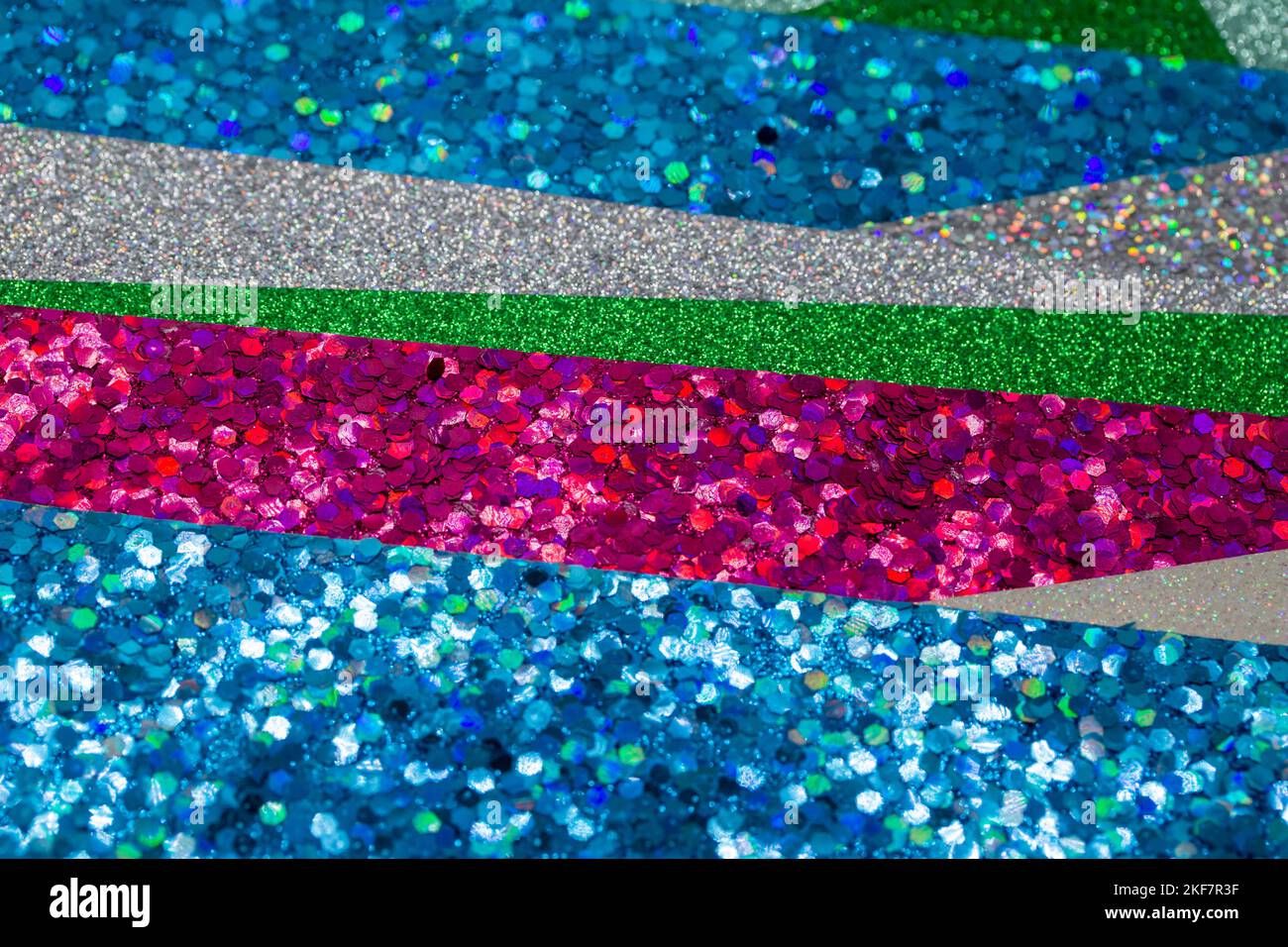 Colorful macro layers of various hued sparkling glitter texture ...