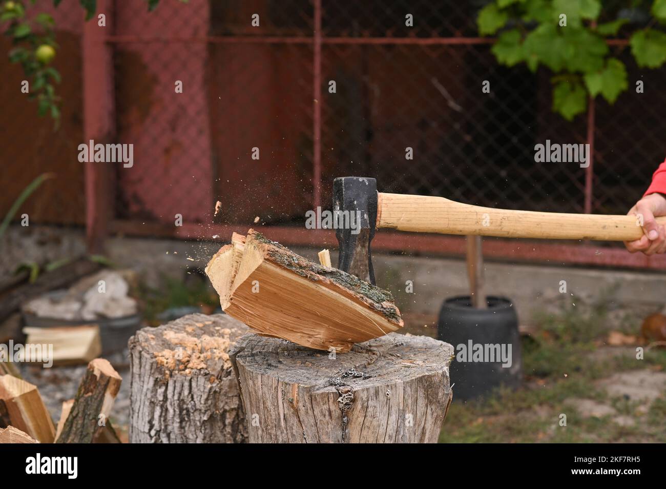 the axe cleaver splits a wooden log in half. Preparation for the ...