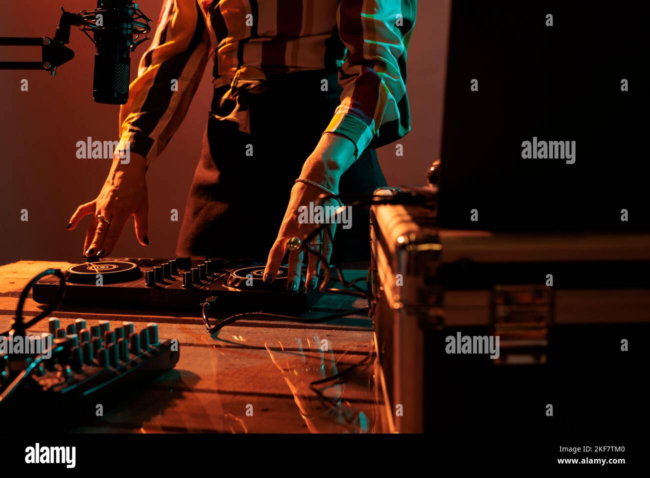 Woman artist using mixing turntables to play music at party, having fun ...