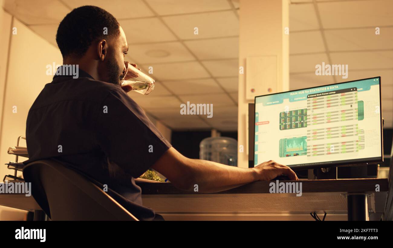 Corporate employee analyzing stock market real time trend and financial ...
