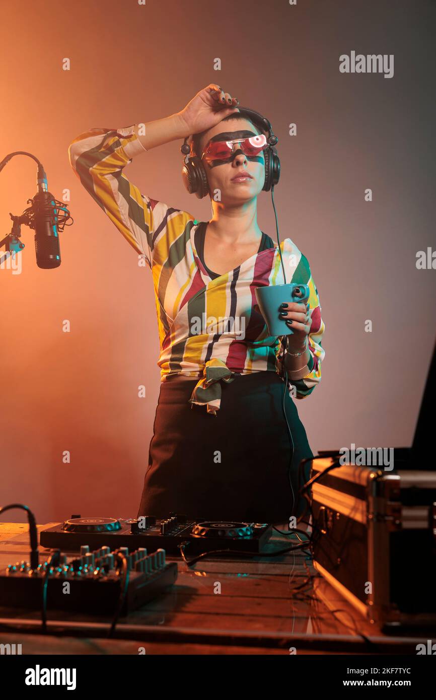 Tired musician drinking coffee and yawning, feeling exhausted after ...