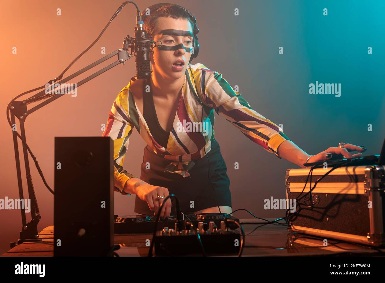Disc jockey mixing techno music with turntables, musical performer ...