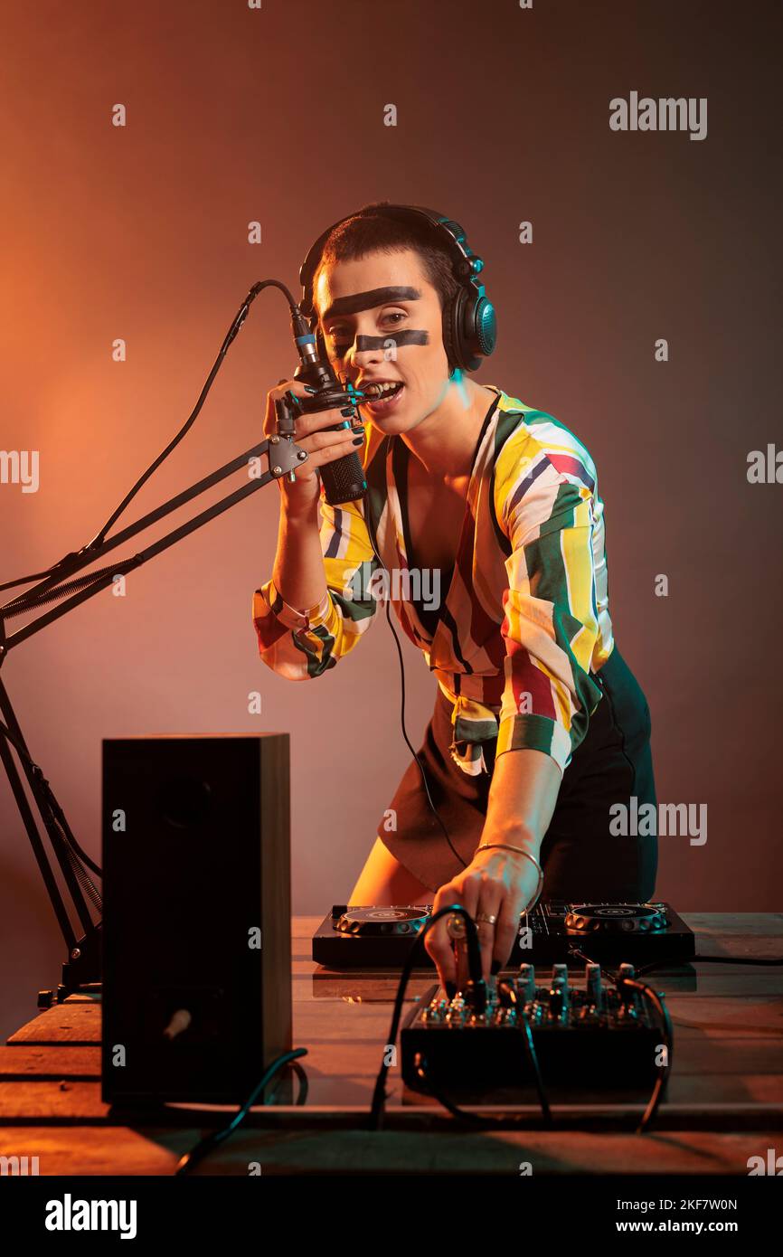 DJ woman using mixer turntables for musical performance, mixing techno ...