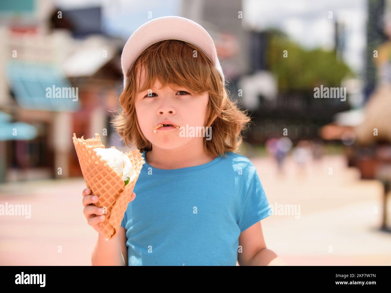 Child eating ice cream. Beautiful little boy eats ice-cream in the ...