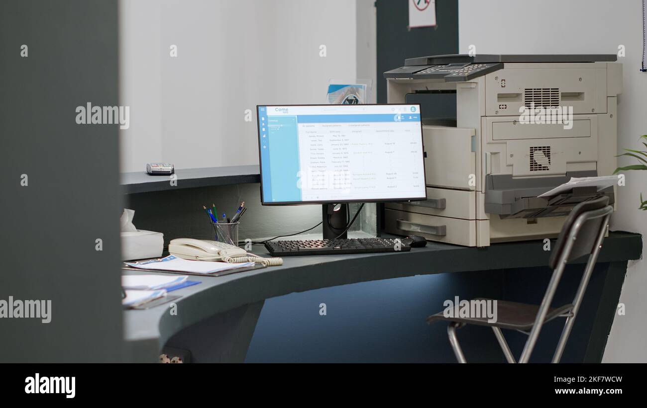 Reception counter in health center to make appointments on computer ...