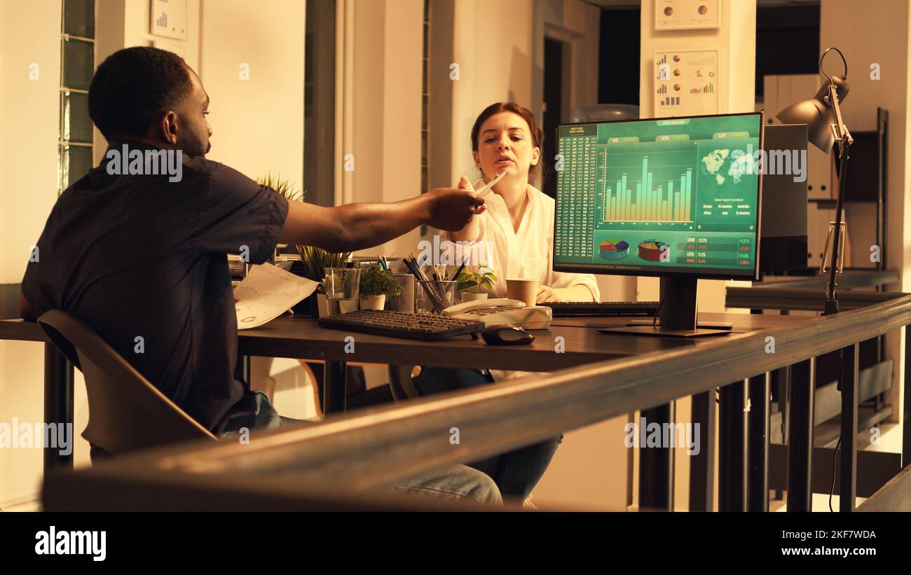 Office Worker Analyzing Financial Data On Computer To Do Research And