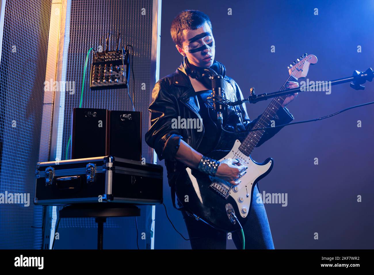 Solo artist performing live show playing guitar, feeling heavy metal ...