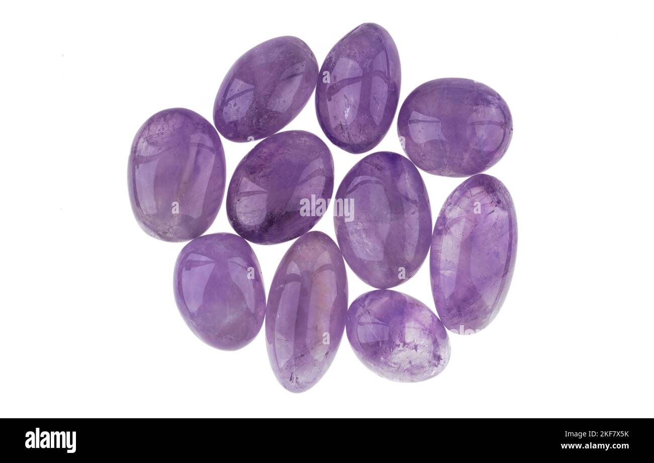 Polished Amethyst gemstones isolated on white background. Oval shaped ...