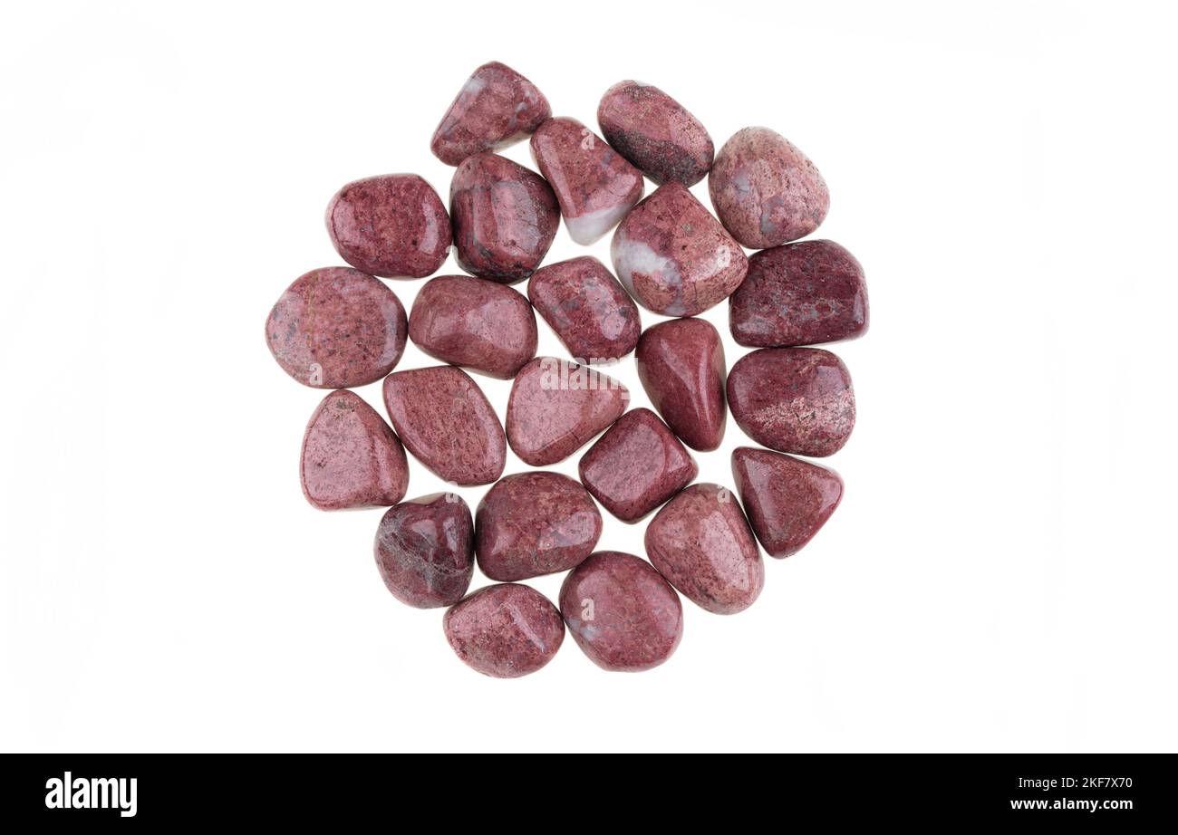 Closeup of Thulite tumbled stones isolated on white background. Thulite ...