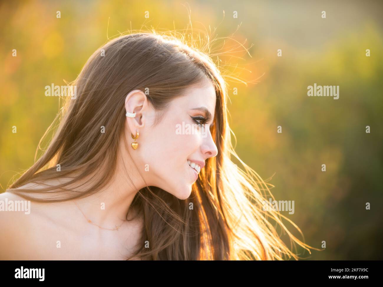 Young woman outdoor enjoying the sunlight. Outdoor portrait of a cute ...