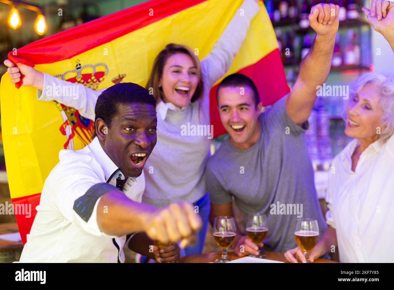Diverse group celebrating with Spanish flag Stock Photo - Alamy