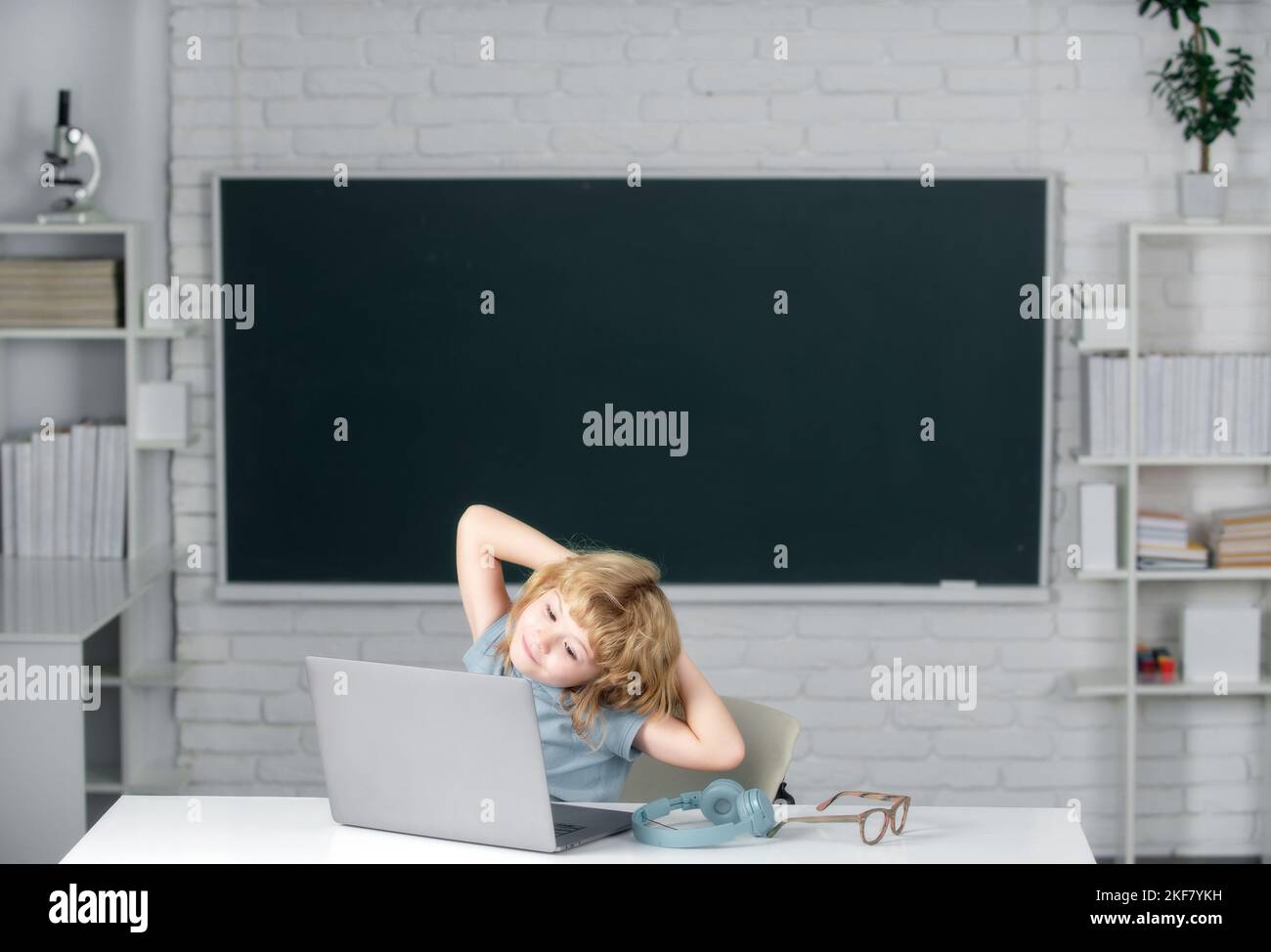 Portrait of attractive cheerful boy using laptop, rest and relaxing ...