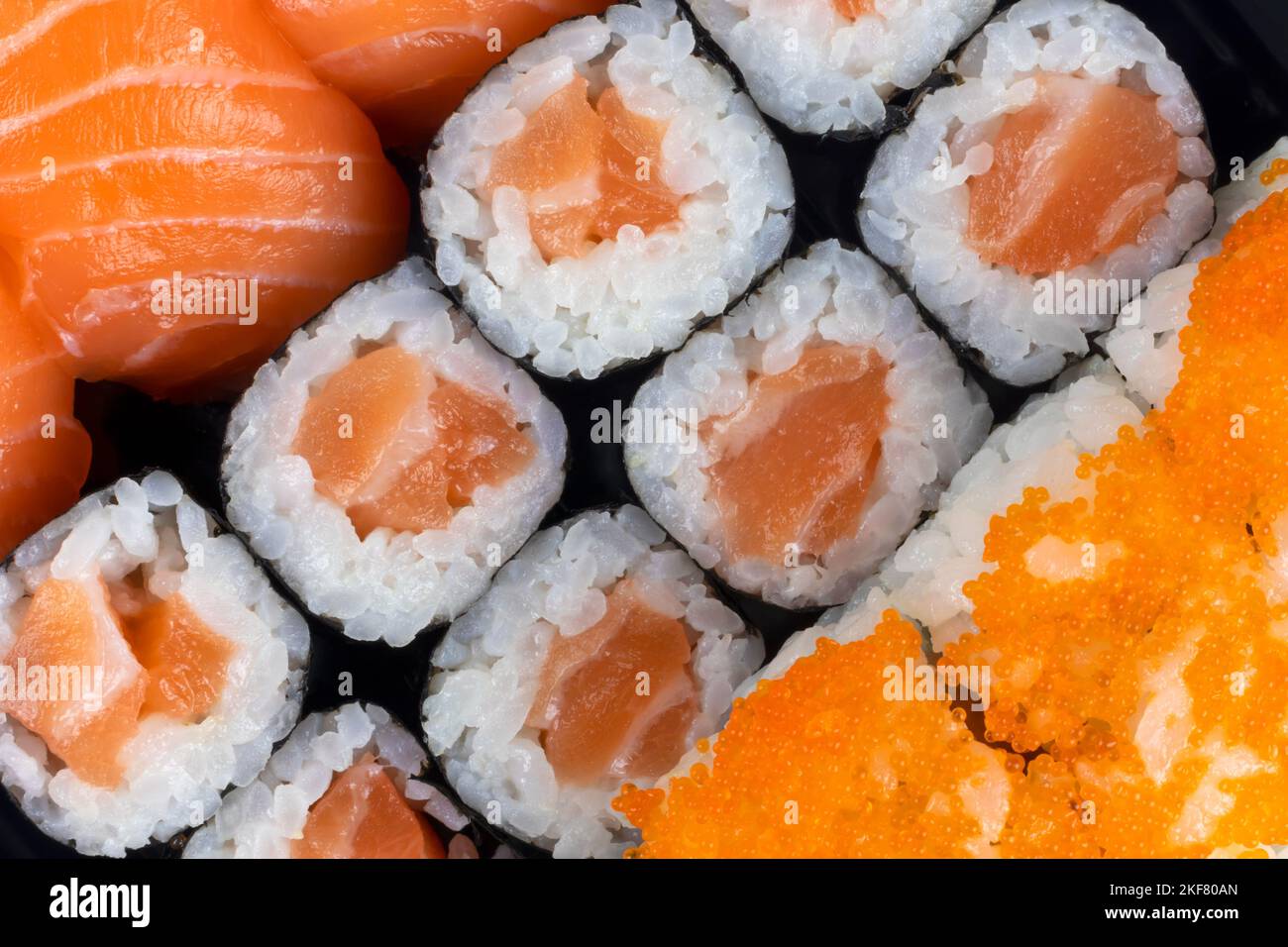 Salmon sushi and sashimi nigiri and maki roll closeup. Delicious ...