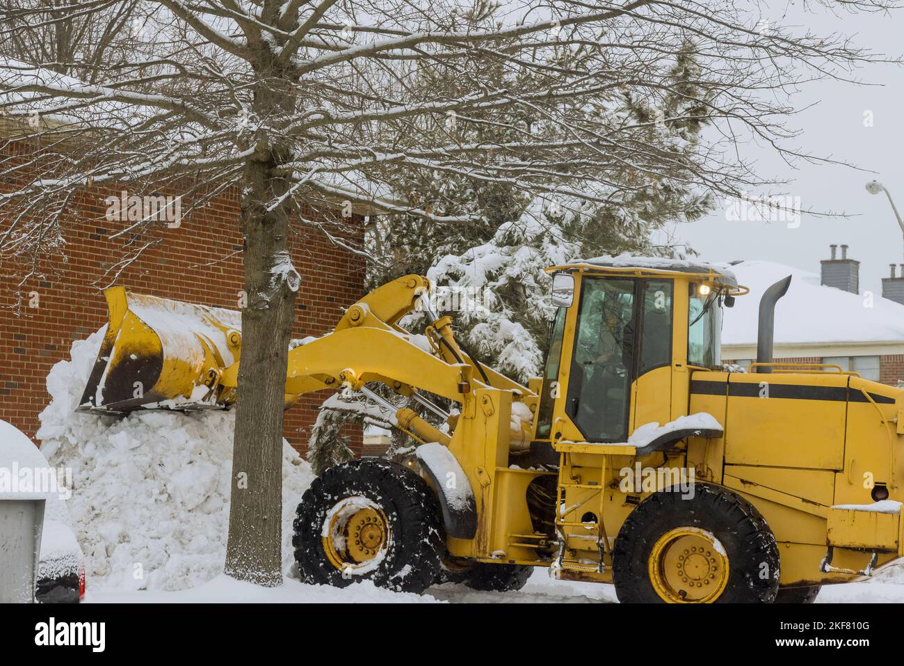 After heavy snowfalls large amount of snowfall crews work with atractor to clear roads snow ...