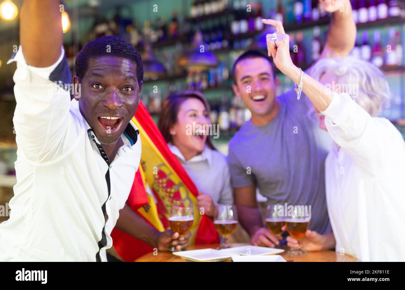 Happy fans celebrating the victory of Spanish team in bar Stock Photo ...