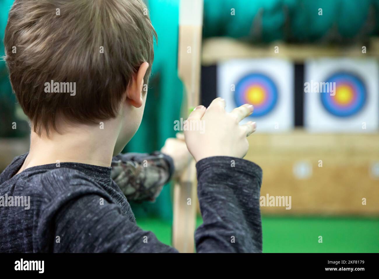 boy shoots at target with bow Stock Photo - Alamy