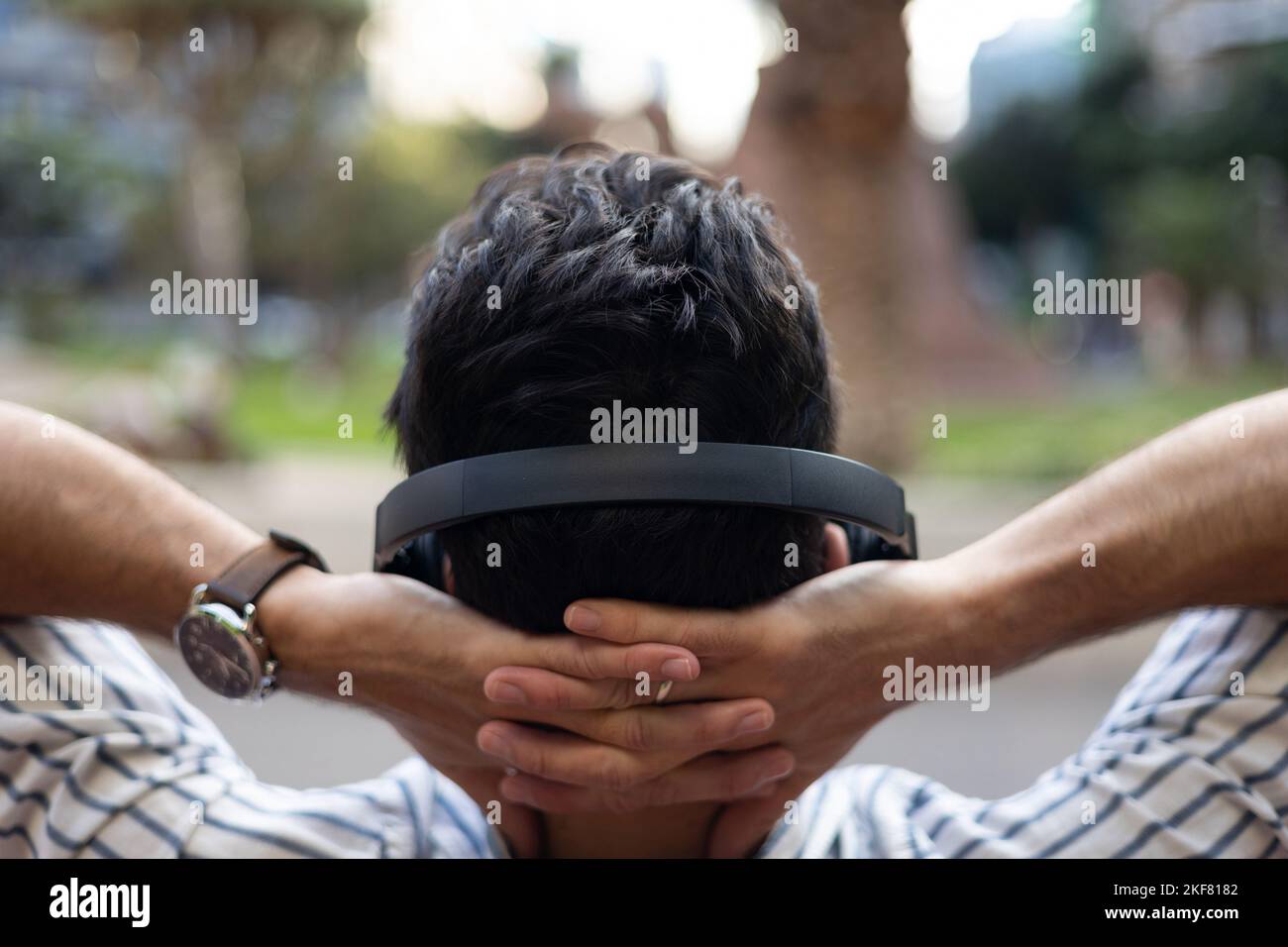 Man on his back resting with his arms on his head Stock Photo - Alamy