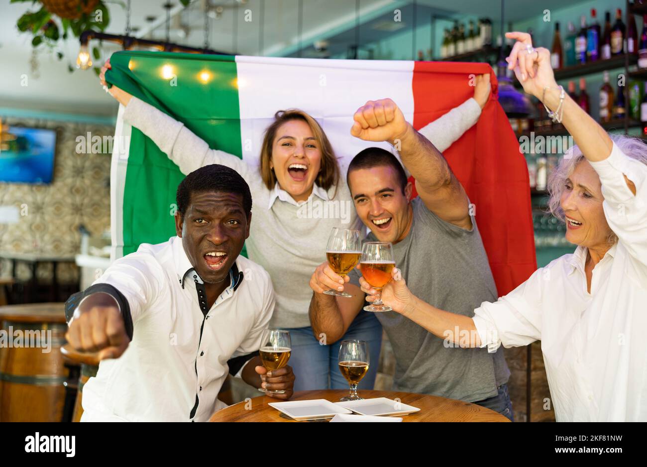 Happy multiracial friends celebrate victory when sports team wins and ...