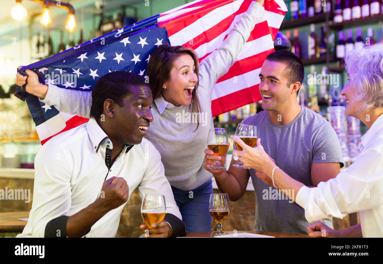 Diverse group celebrating with American flag Stock Photo - Alamy