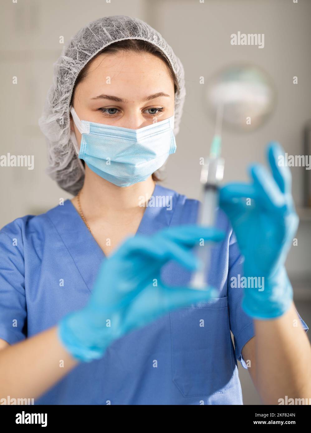 Female nurse in mask holding syringe for injection Stock Photo - Alamy