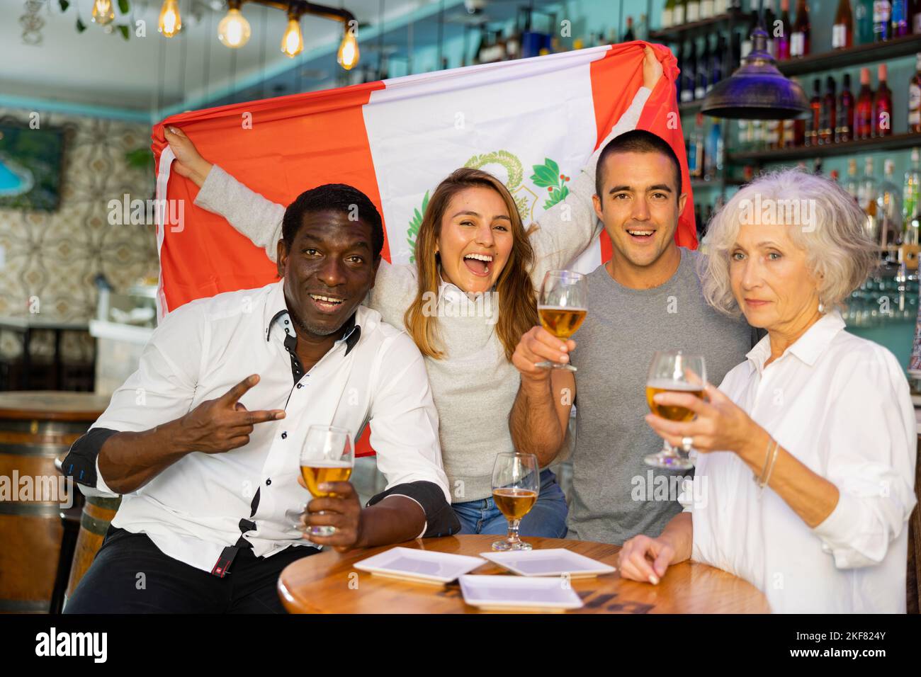 Happy friends celebrating the victory of the Peruvian team in beer bar ...
