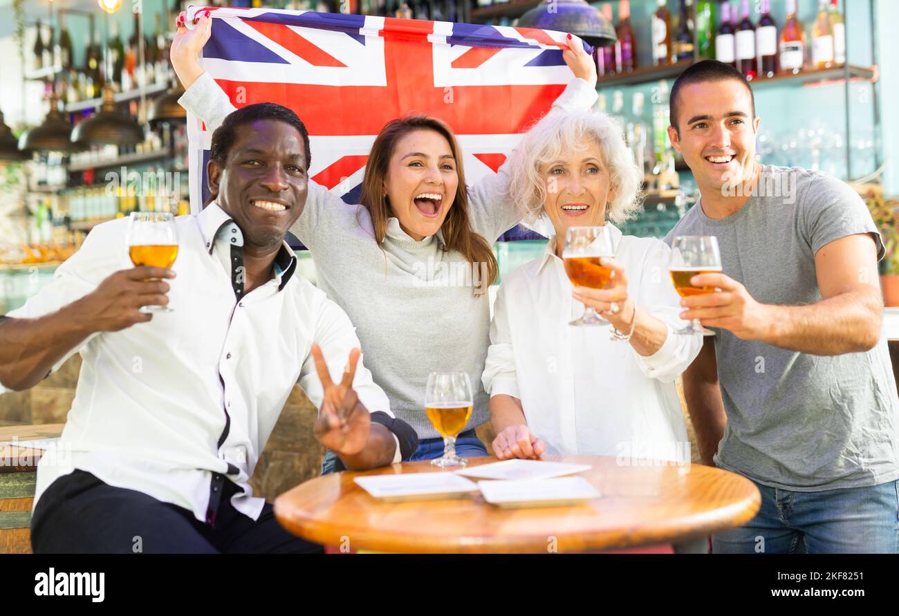 Diverse group celebrating with British flag Stock Photo - Alamy