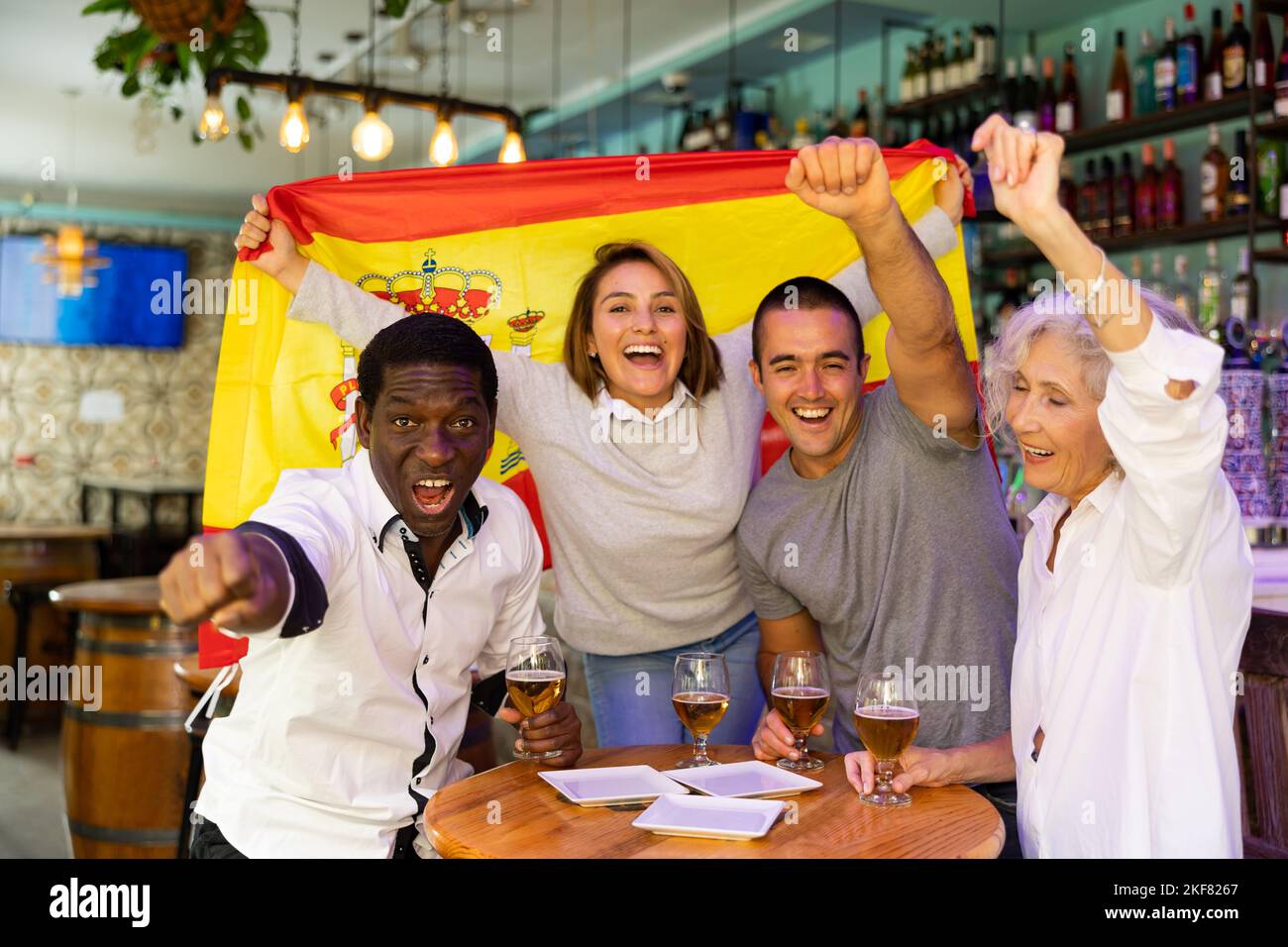 Diverse group celebrating with Spanish flag Stock Photo - Alamy