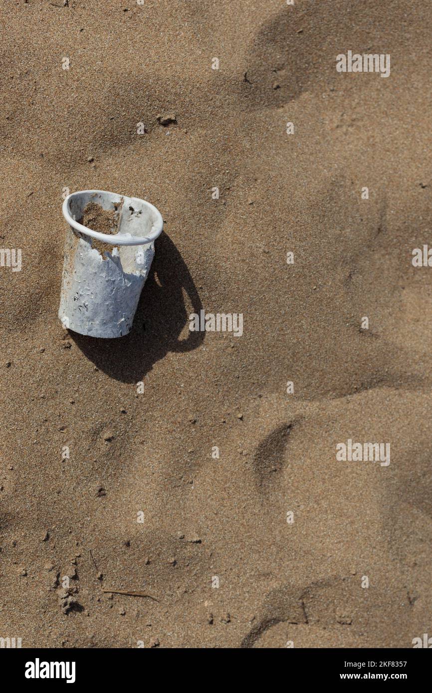 Abandoned plastic cup on beach, probelm of microplastic contamination ...
