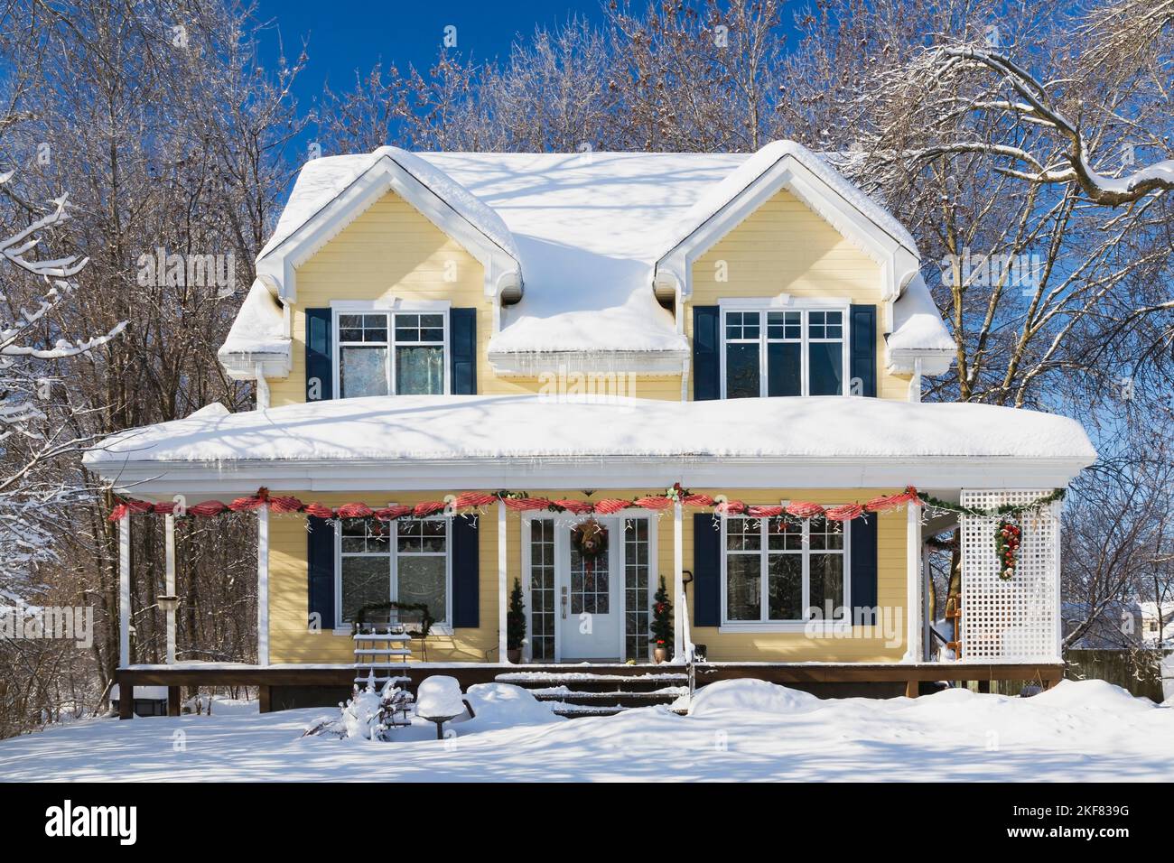 Yellow clapboard with blue and white trim cottage style home facade ...