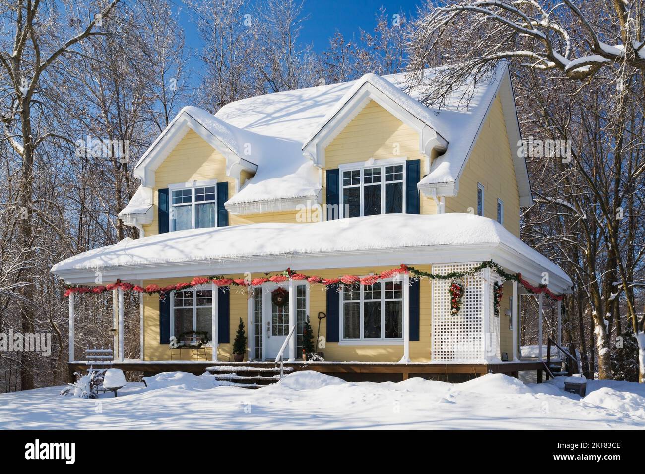 Yellow clapboard with blue and white trim cottage style home facade ...