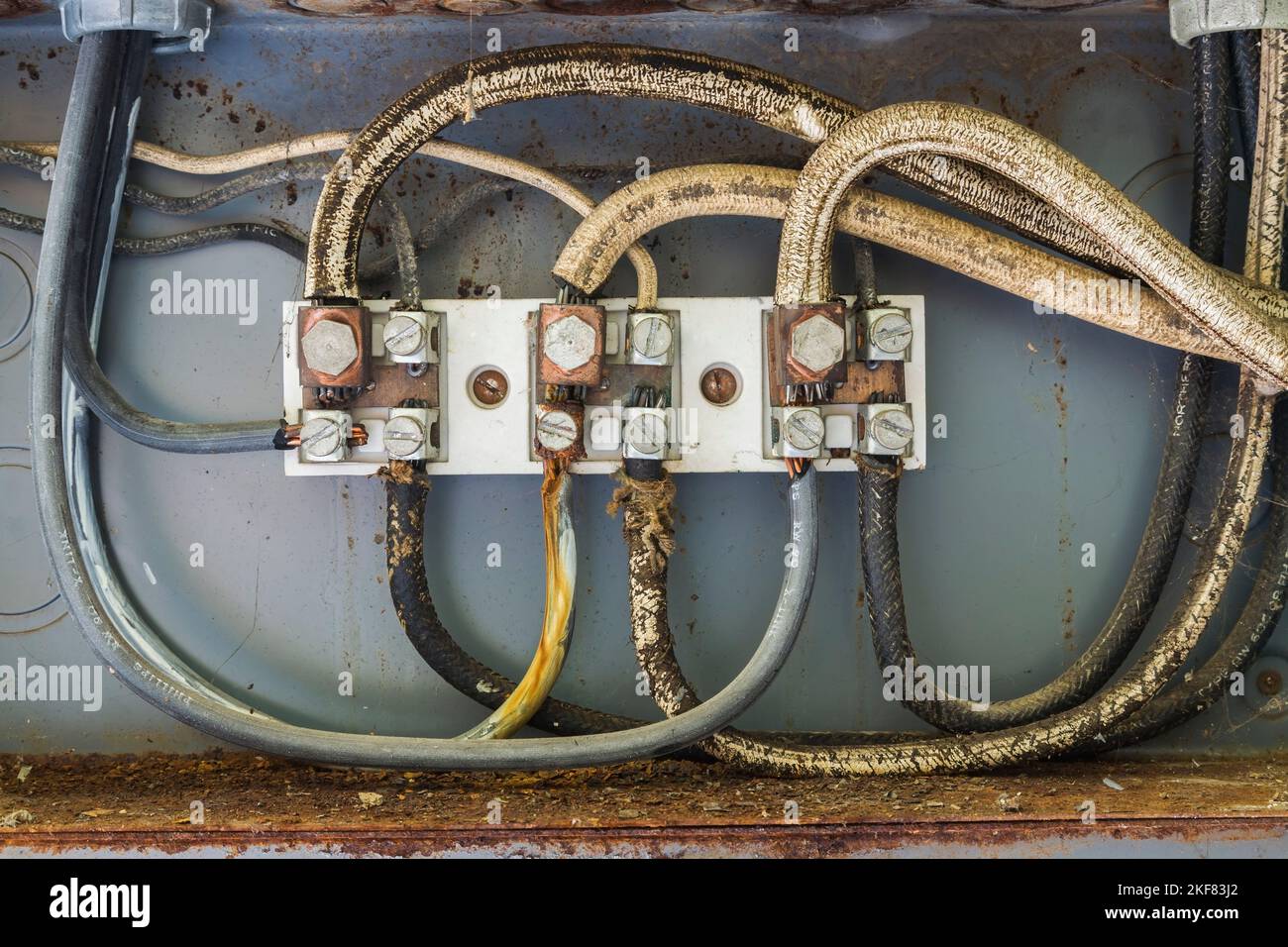 Close-up of old and dirty cloth sheathed electrical cables in an opened ...