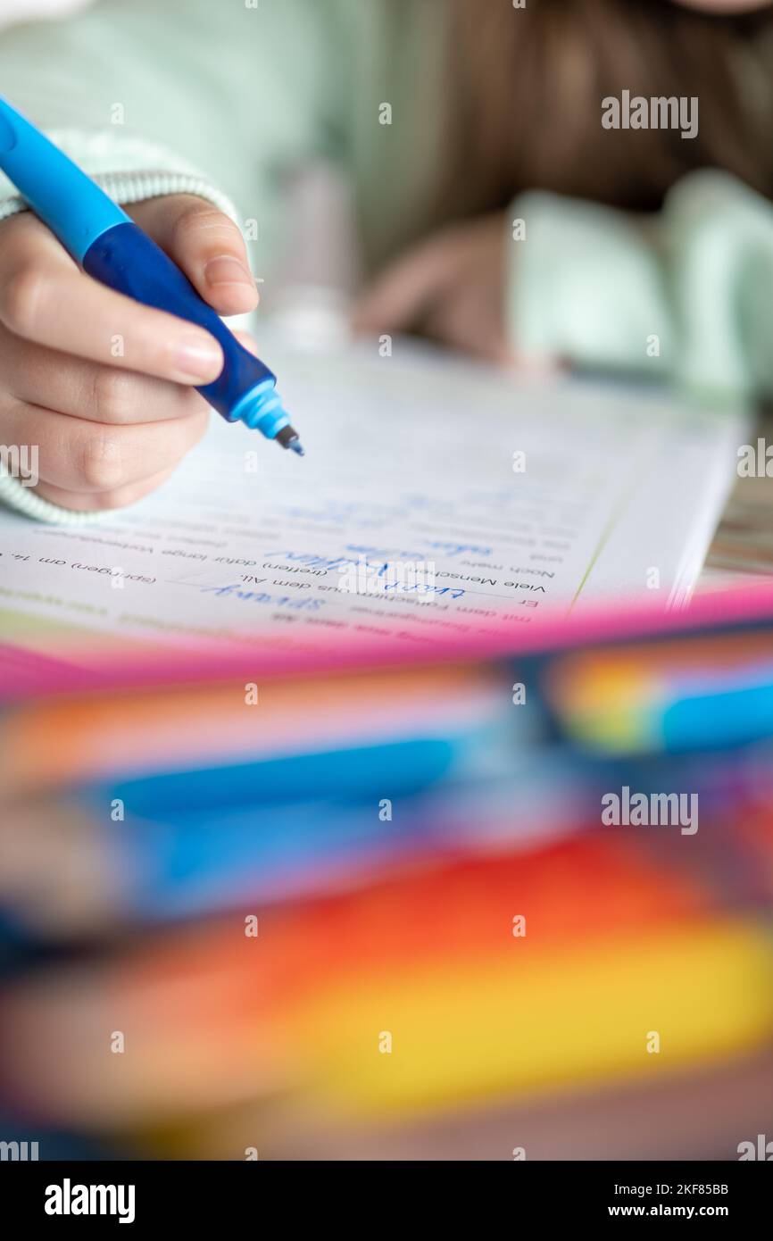 child writes with a pencil in a notebook.Close-up pencil in a childs ...