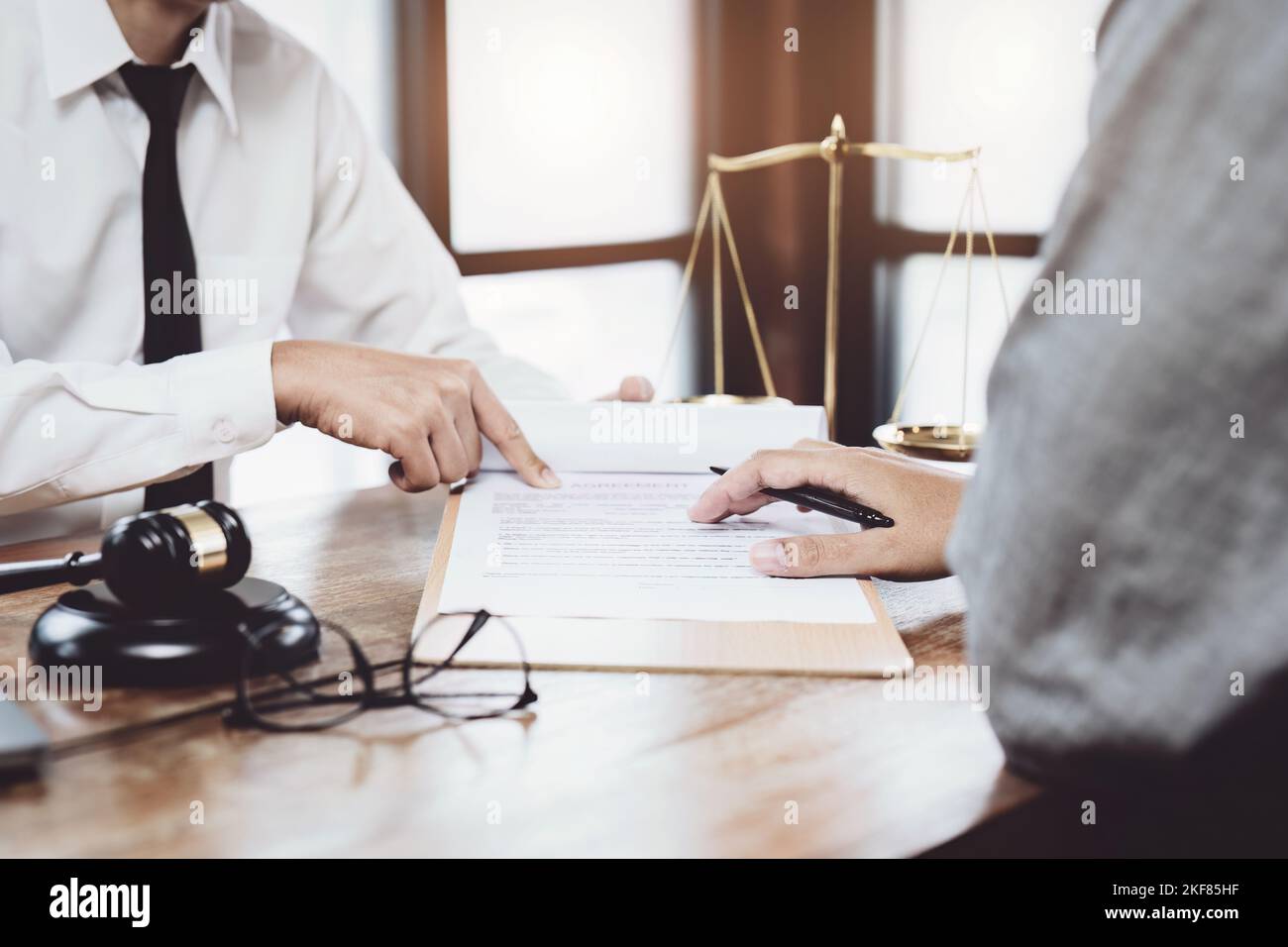 Discussing legal matters and signing important documents Stock Photo ...