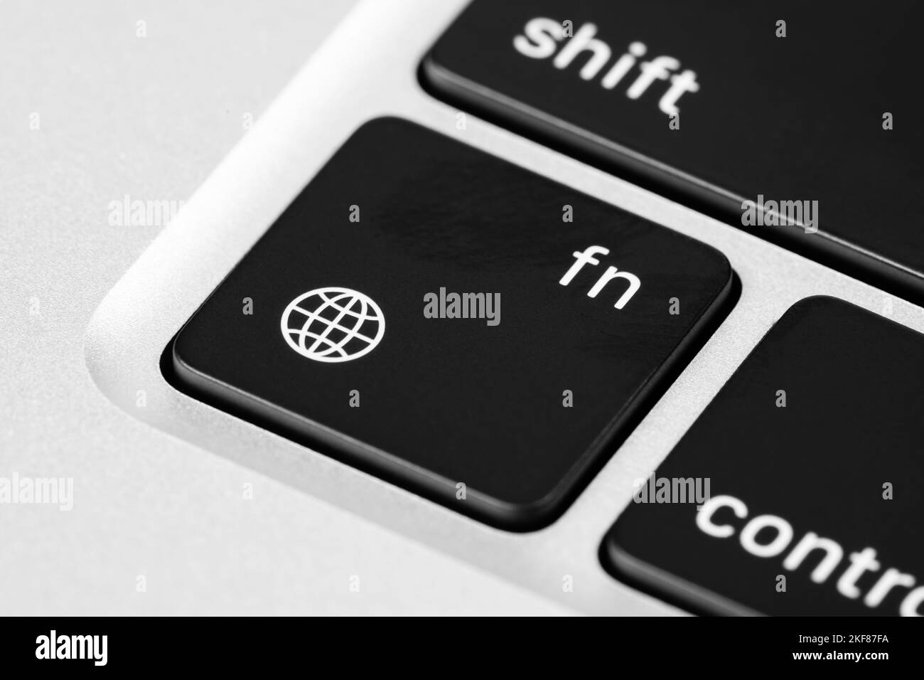 A closeup shot of a grey keyboard layout with black keys and white font ...