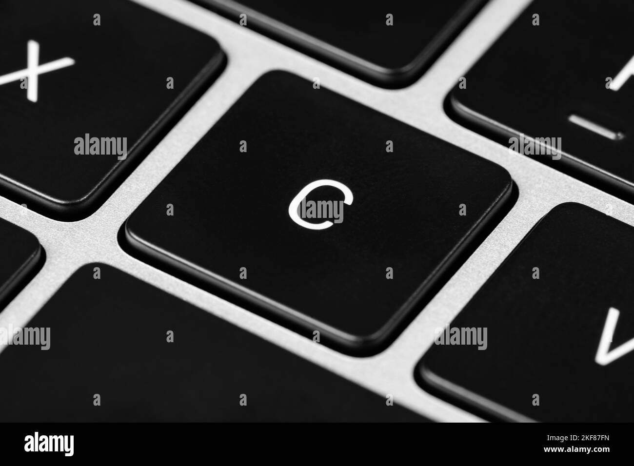 A closeup shot of a grey keyboard layout with black keys and white font ...