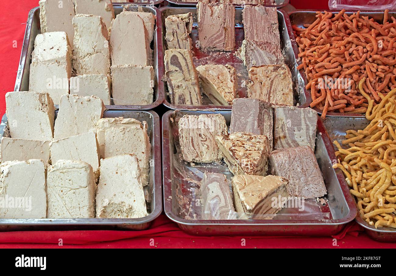 Traditional Arabian sweets halva sold on local market next to fried ...