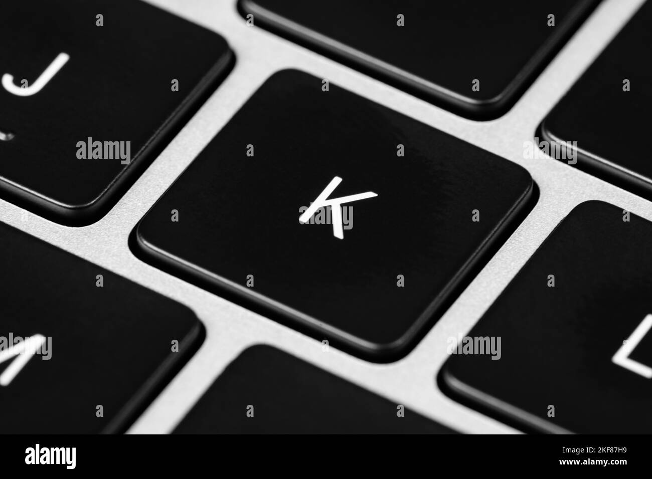 A closeup shot of a grey keyboard layout with black keys and white font ...