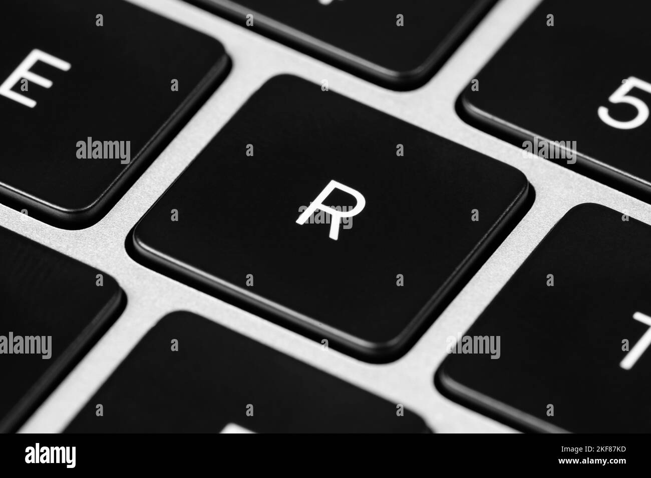 A closeup shot of a grey keyboard layout with black keys and white font ...