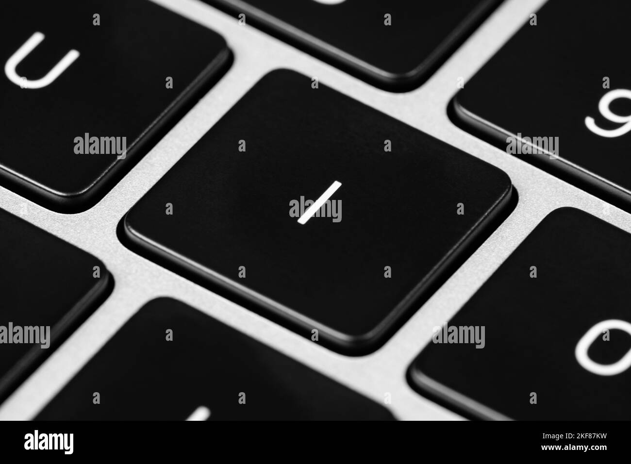 A closeup shot of a grey keyboard layout with black keys and white font ...