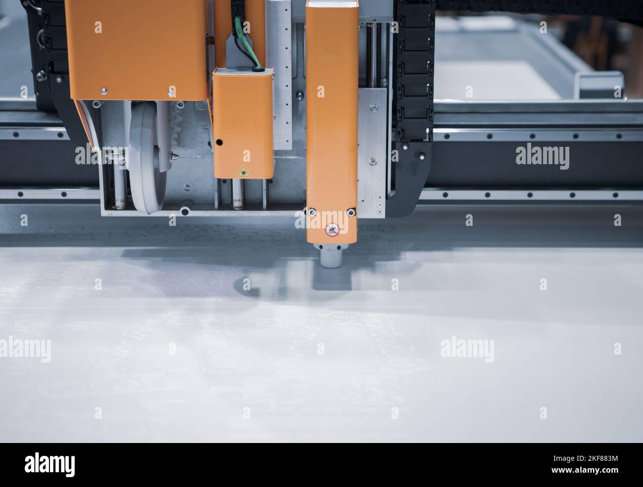 Digital die cut machine cutting plastic sheet. Industrial manufacture ...