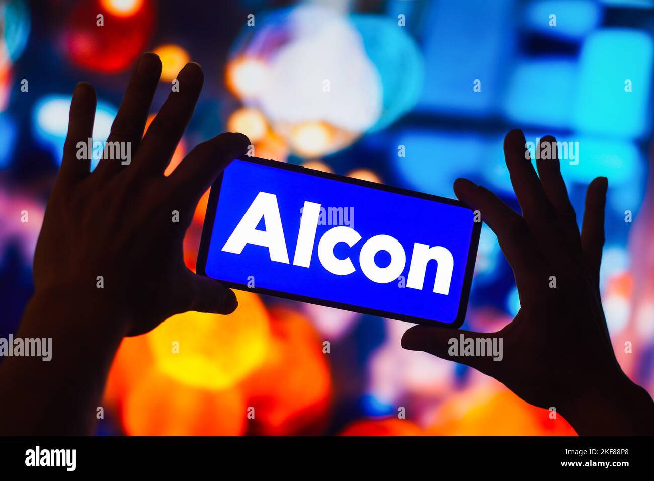 In this photo illustration, the Alcon logo is displayed on a smartphone ...