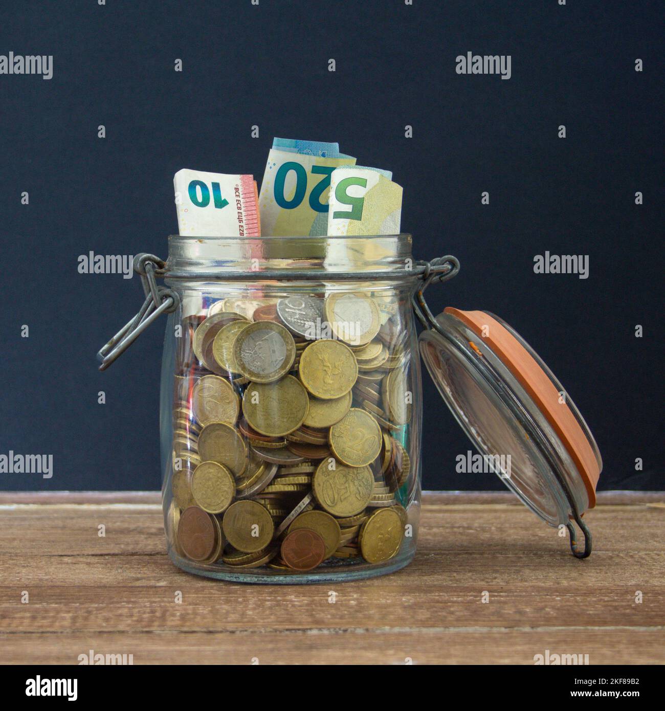 Image of a mason jar full of coins and bills spilling out Stock Photo ...