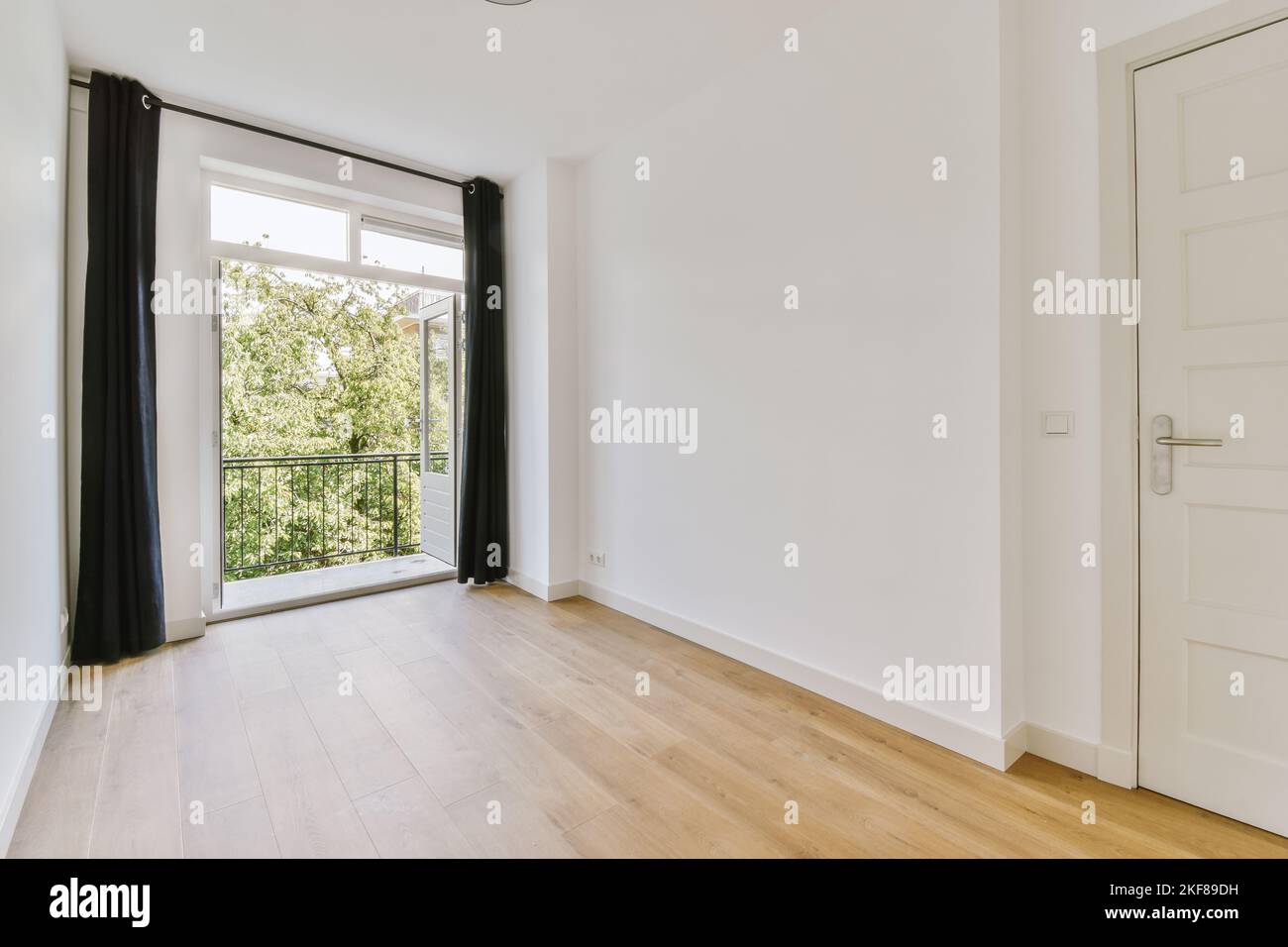 Plastic window and radiator on white wall in empty light room at home ...