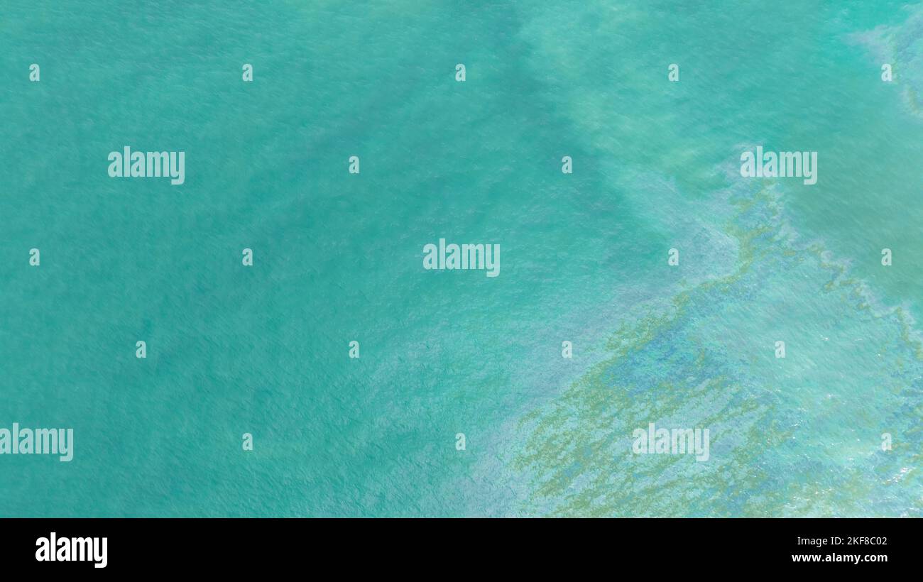 Oil spill in sea water. Gasoline leaks into the ocean. Dirty water in ...