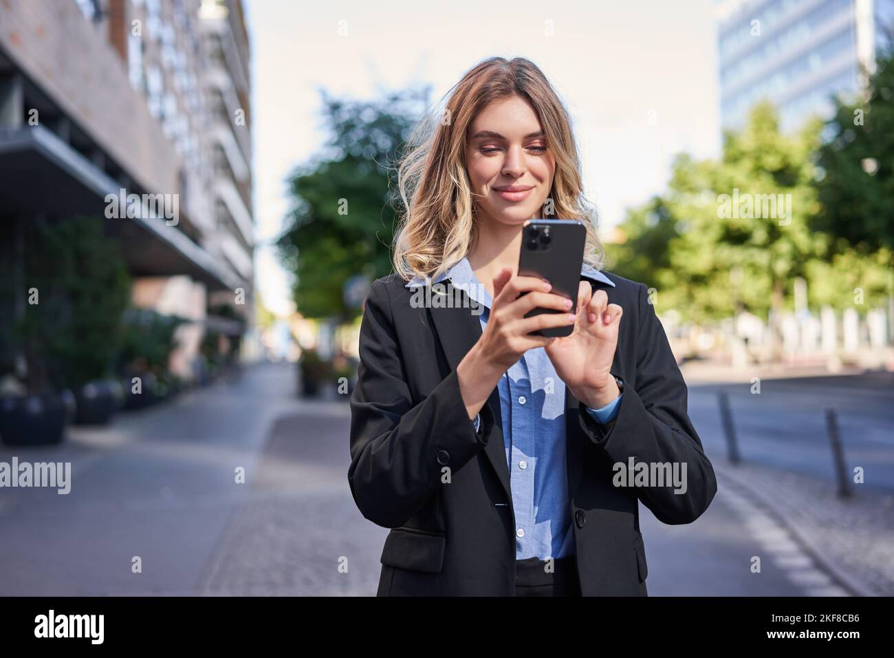 Portrait of young smiling saleswoman, businesswoman looking at her ...