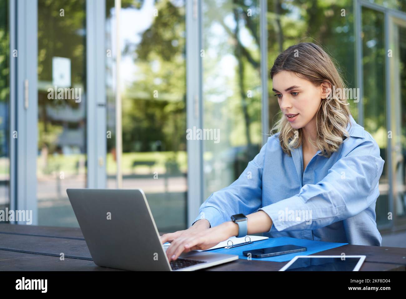 Successful businesswoman working outdoors, sitting on fresh air with ...