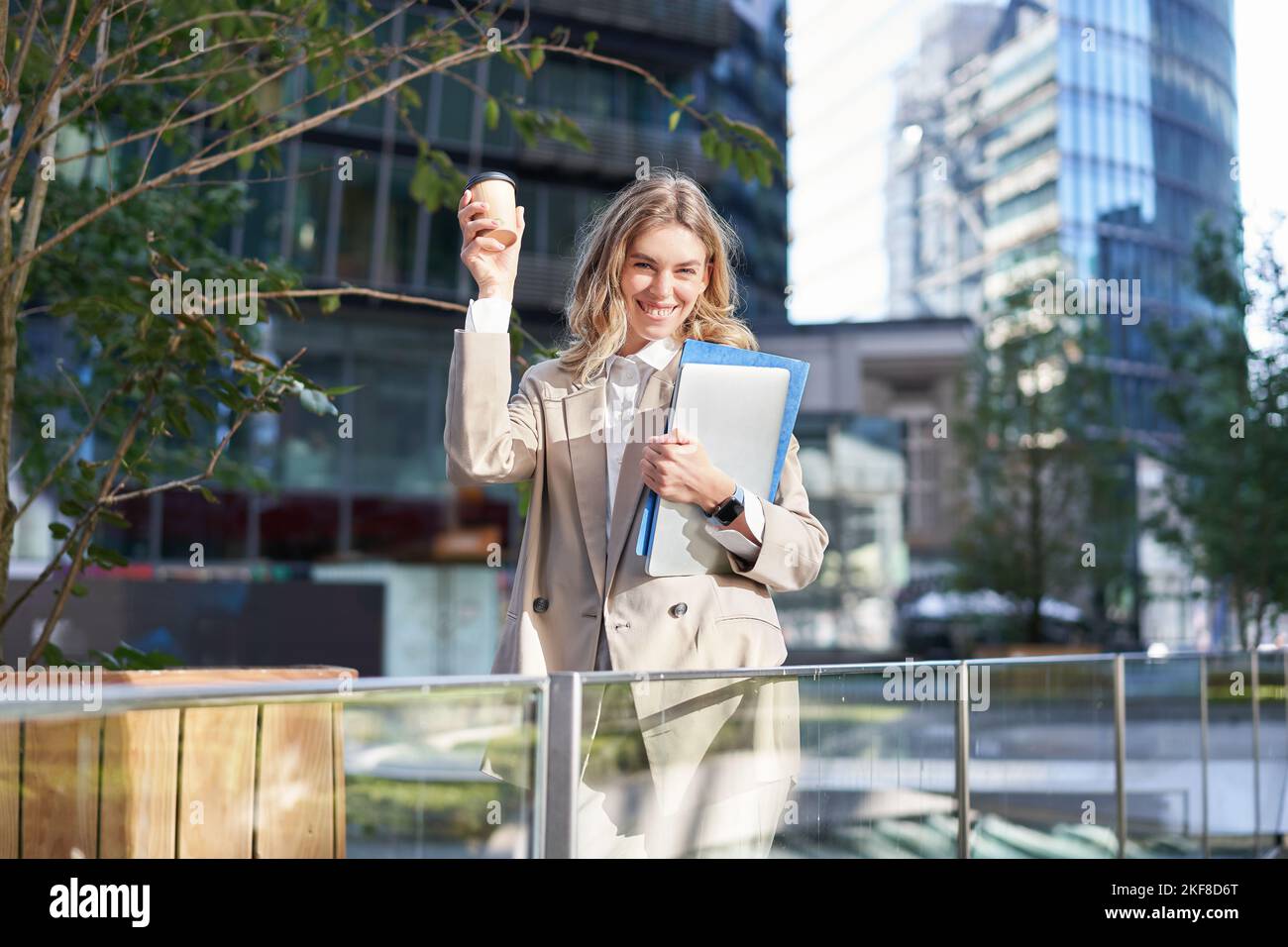 Enthusiastic businesswoman feels upbeat after morning cup of coffee ...