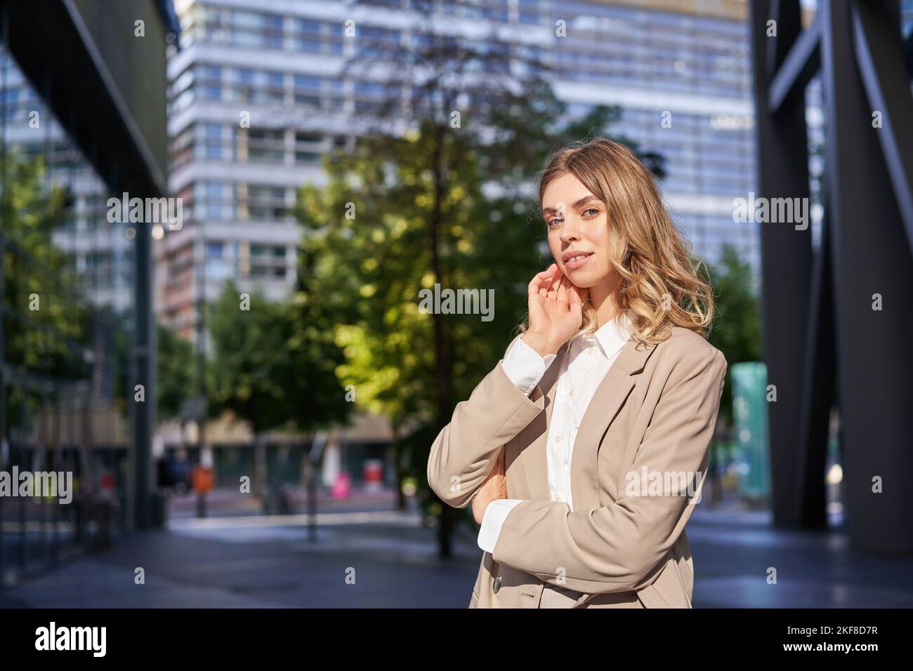 Successful working woman, office manager in suit, cross arms on chest ...